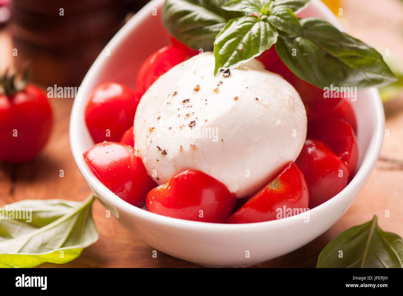 Caprese salad with baby mozzarella cheese Stock Photo - Alamy