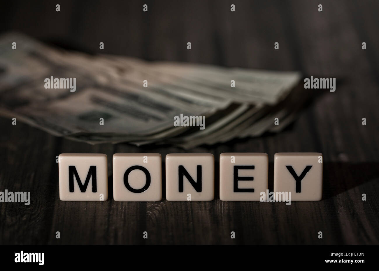 Money Spelled Out in Tiles Stock Photo - Alamy