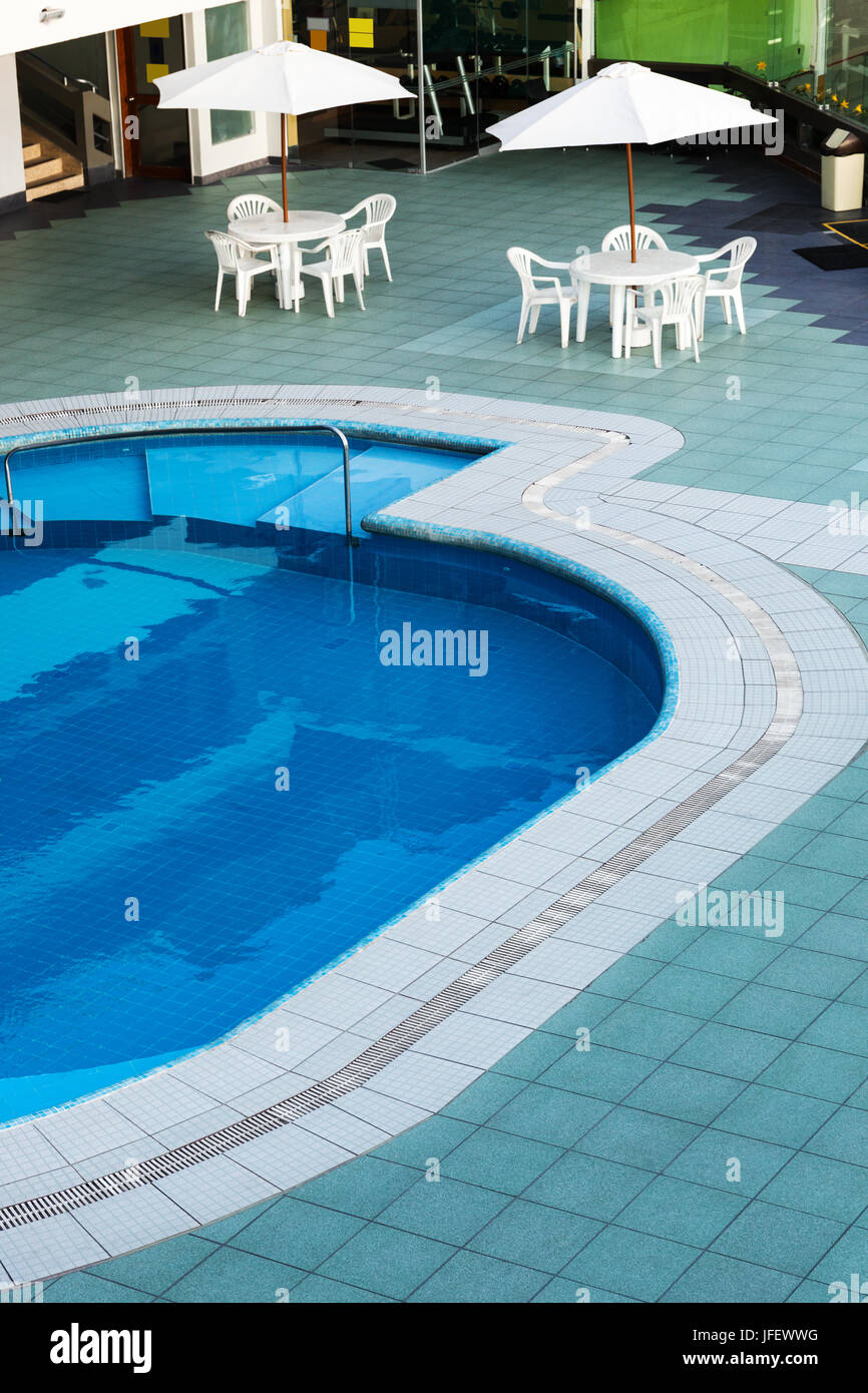 tables and chairs at the pool Stock Photo - Alamy