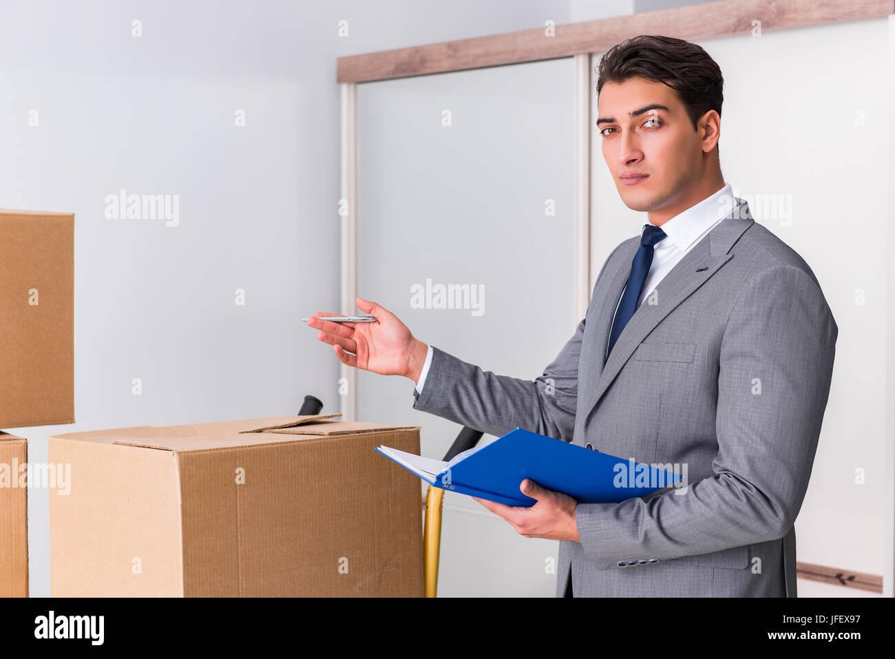 Man signing delivery boxes hi-res stock photography and images - Alamy