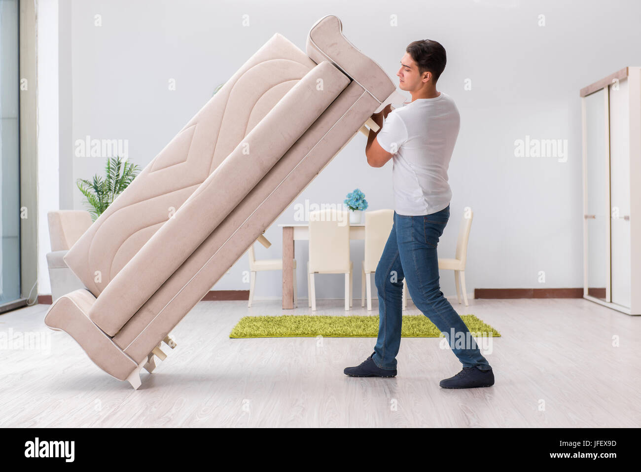 Man moving furniture at home Stock Photo - Alamy