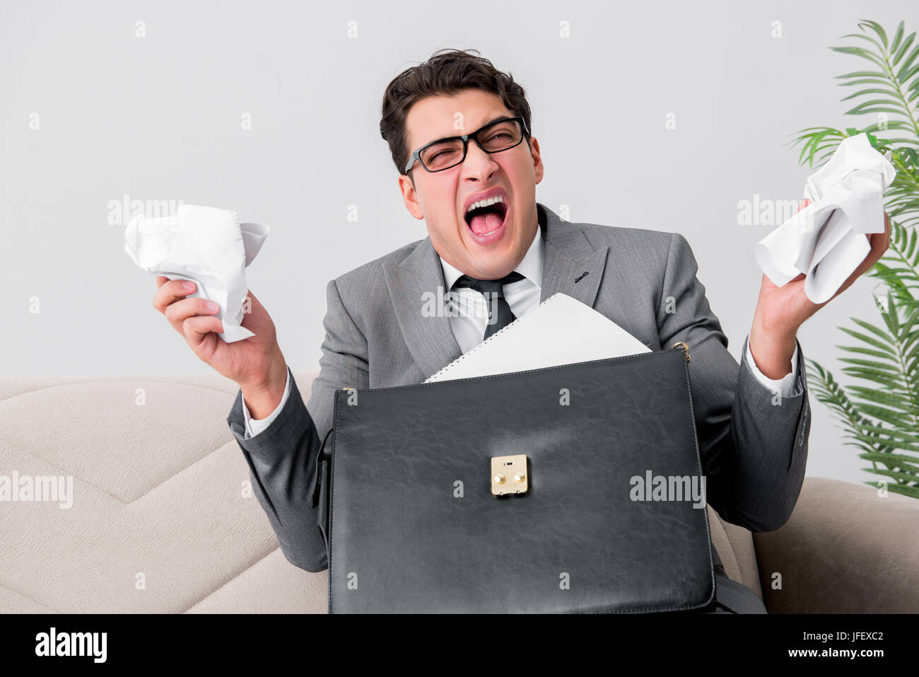 Angry businessman with crumbled paper Stock Photo - Alamy