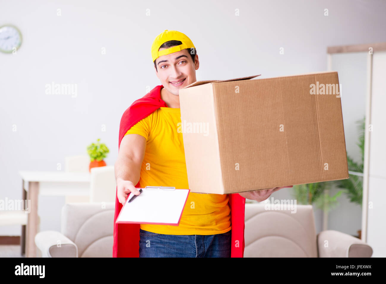 Superhero delivery guy with box Stock Photo - Alamy