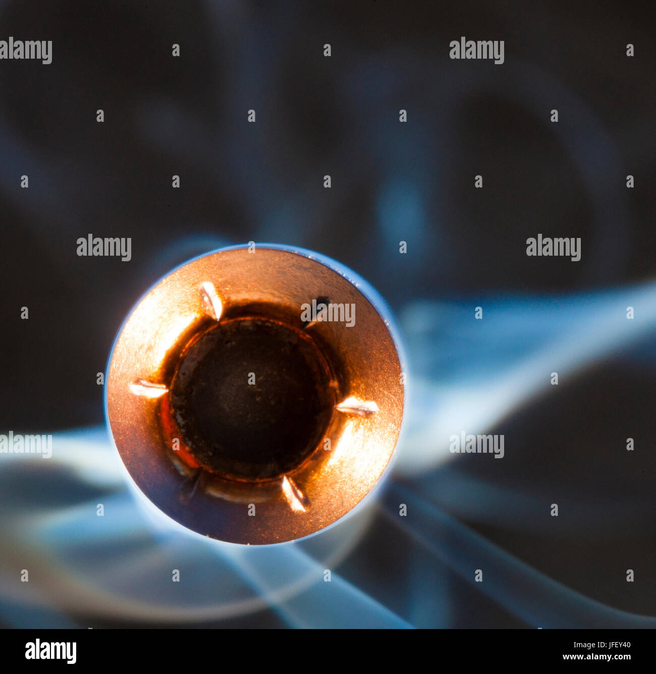 Hollow pont bullet with smoke behind coming at the camera Stock Photo ...