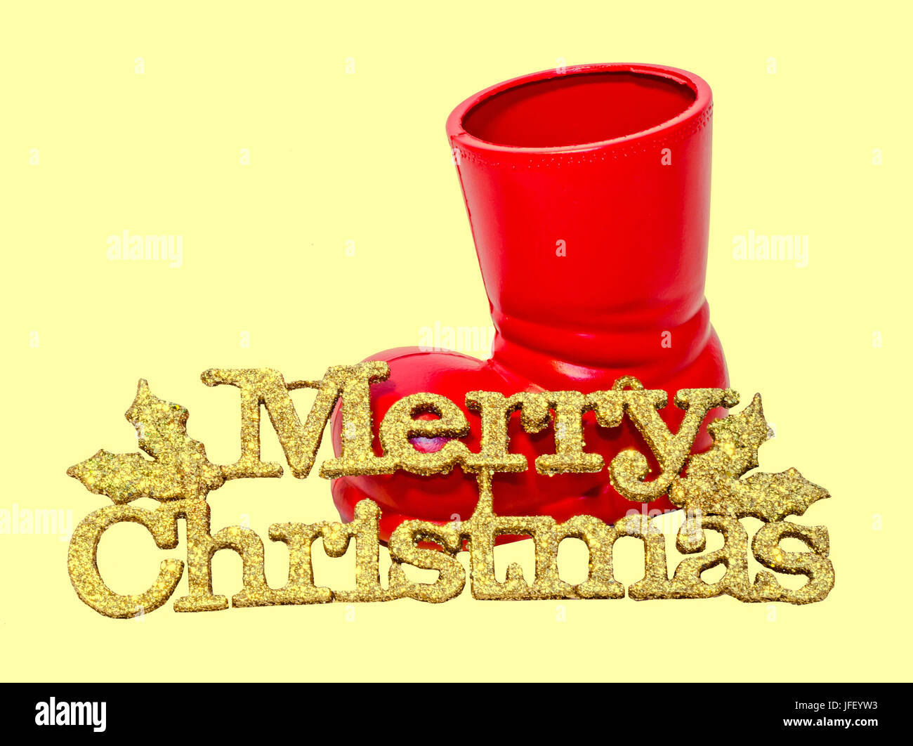 Red Santa shoes with candy sticks and golden Merry Christmas write ...