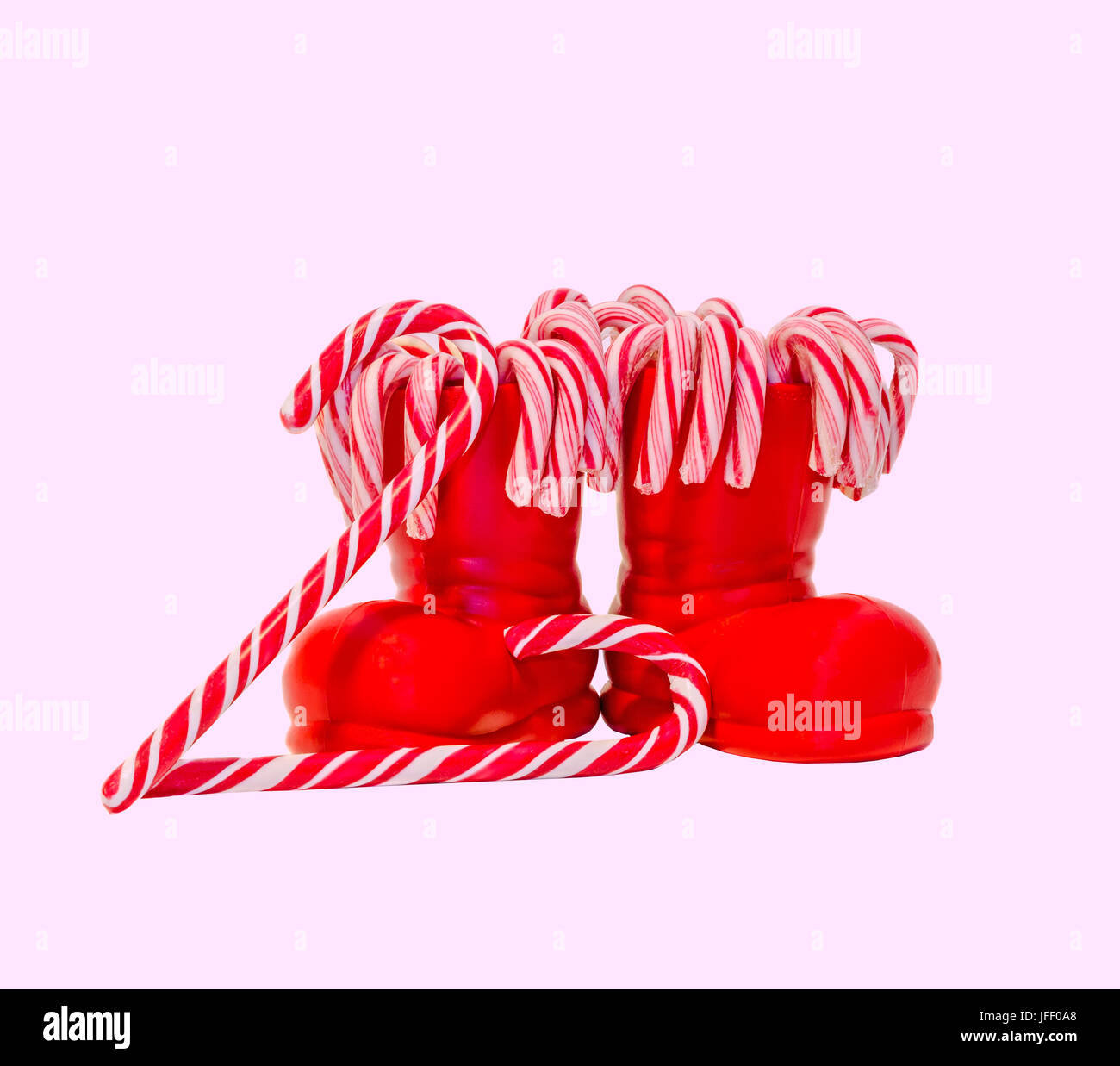 Red Santa shoes with candy sticks, close up, isolated Stock Photo - Alamy