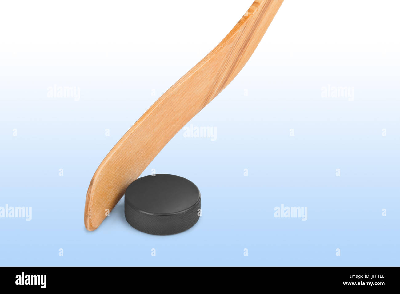 Ice hockey stick and puck Stock Photo - Alamy