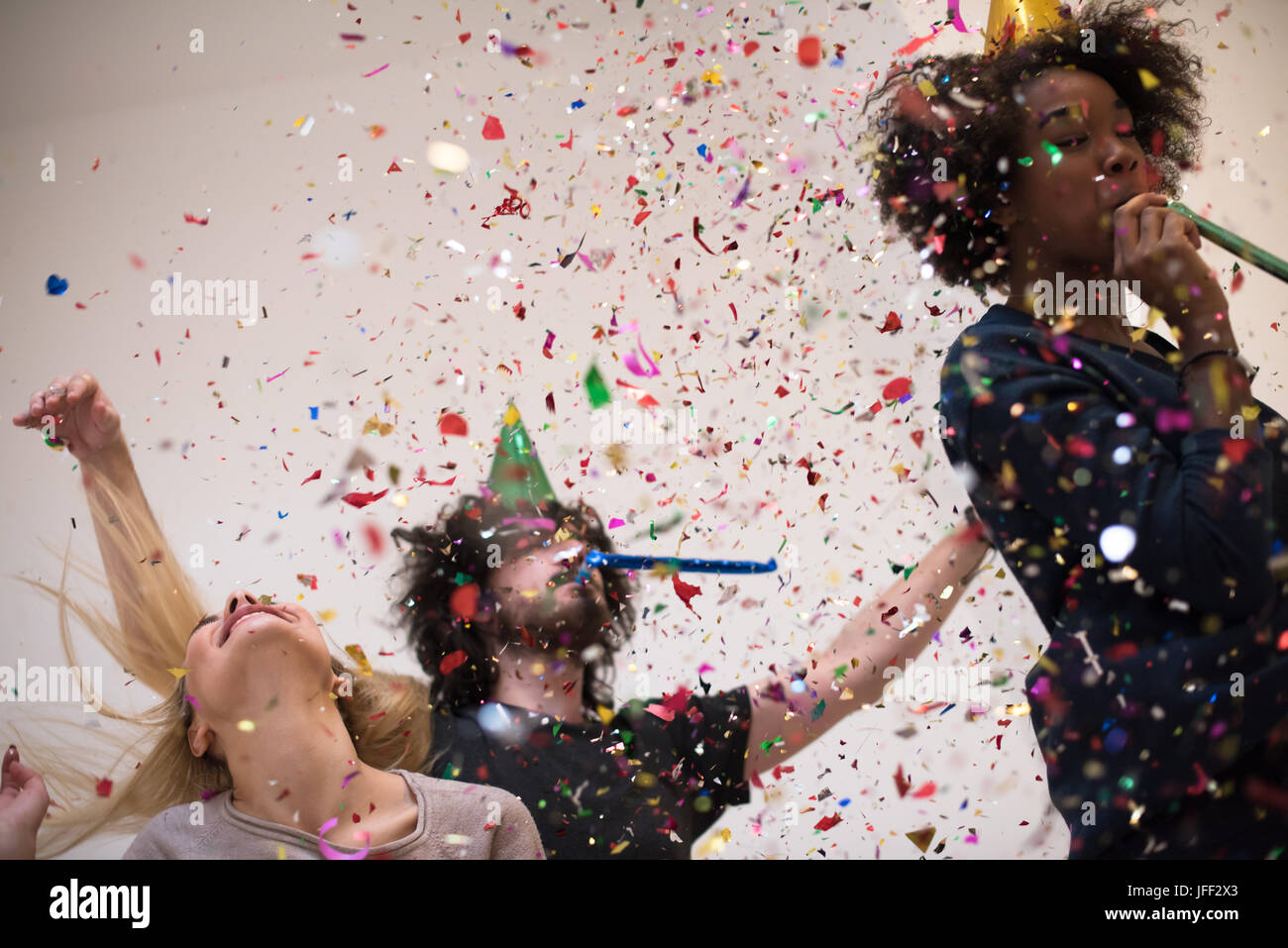 confetti party Multiethnics happy young people group celebrating new ...