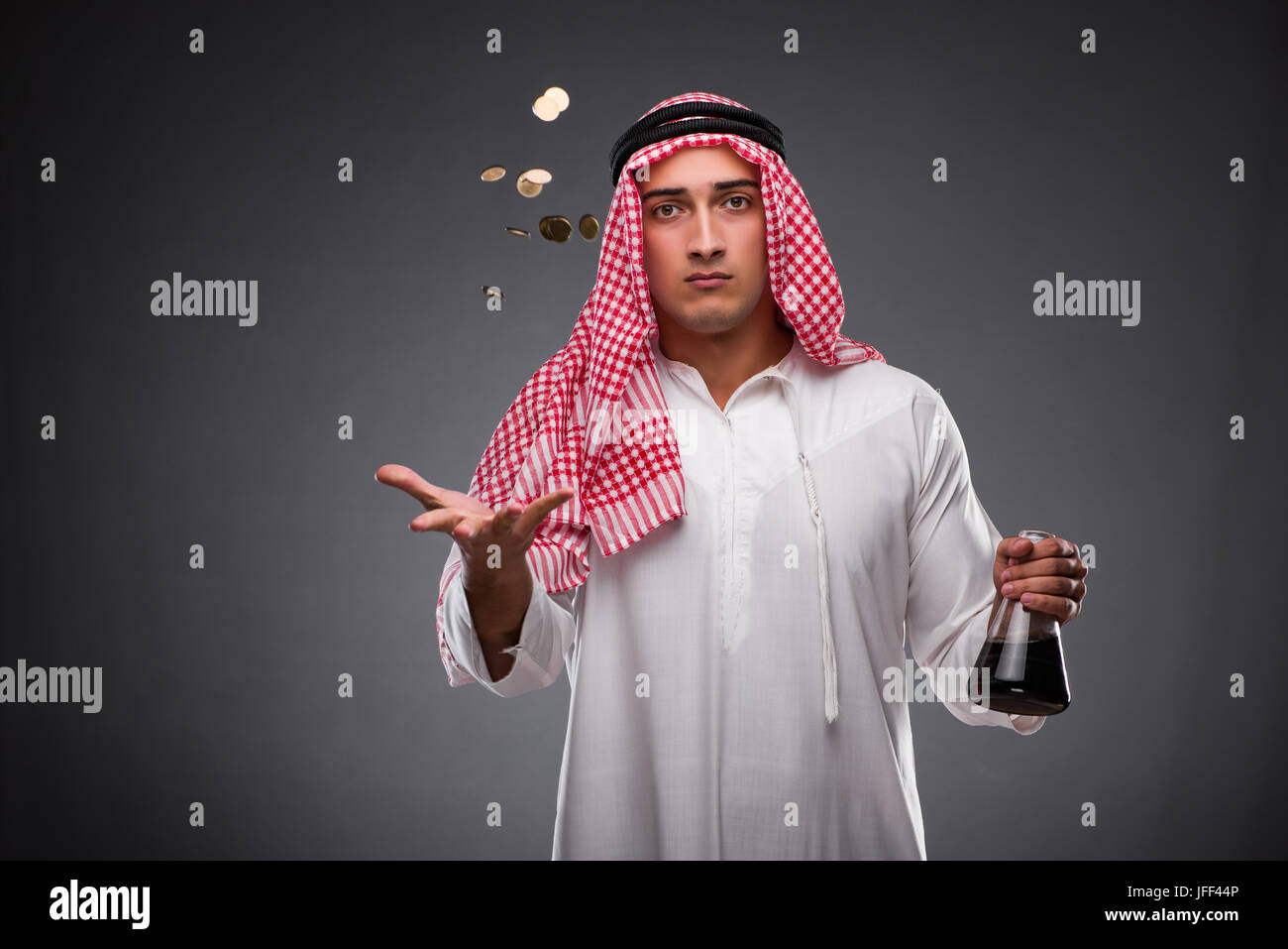 Arab with oil on gray background Stock Photo - Alamy
