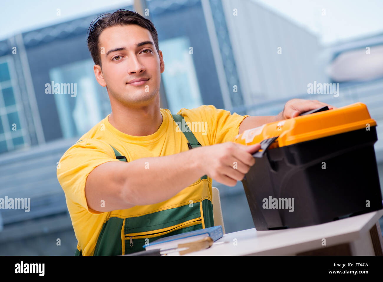 Construction worker sitting at the desk Stock Photo - Alamy