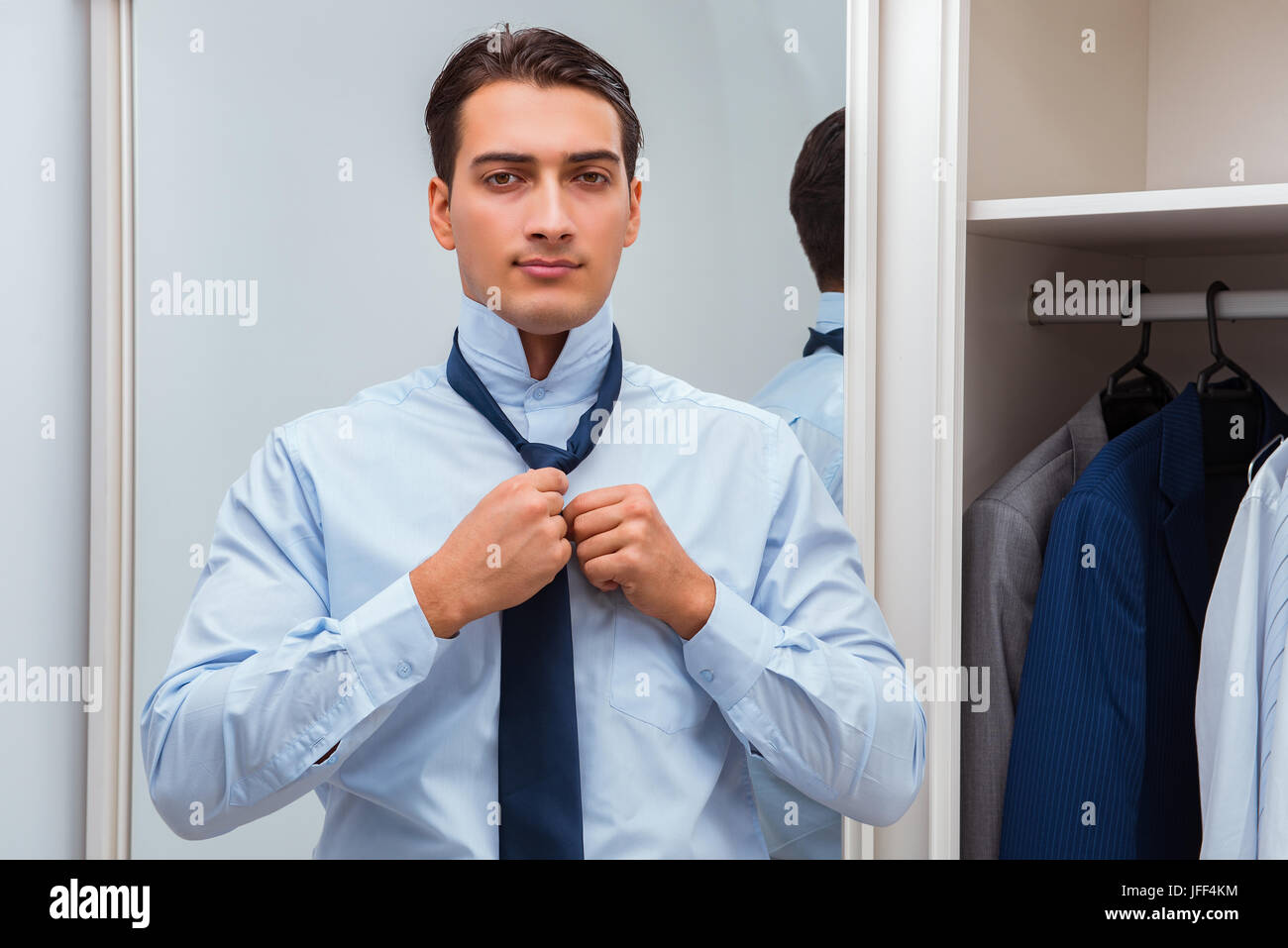 Businessman dressing up for work Stock Photo - Alamy