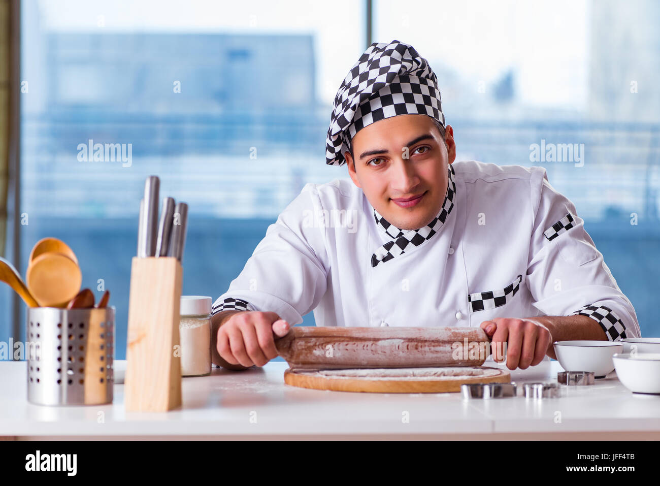 Young man cooking cookies in kitchen Stock Photo - Alamy