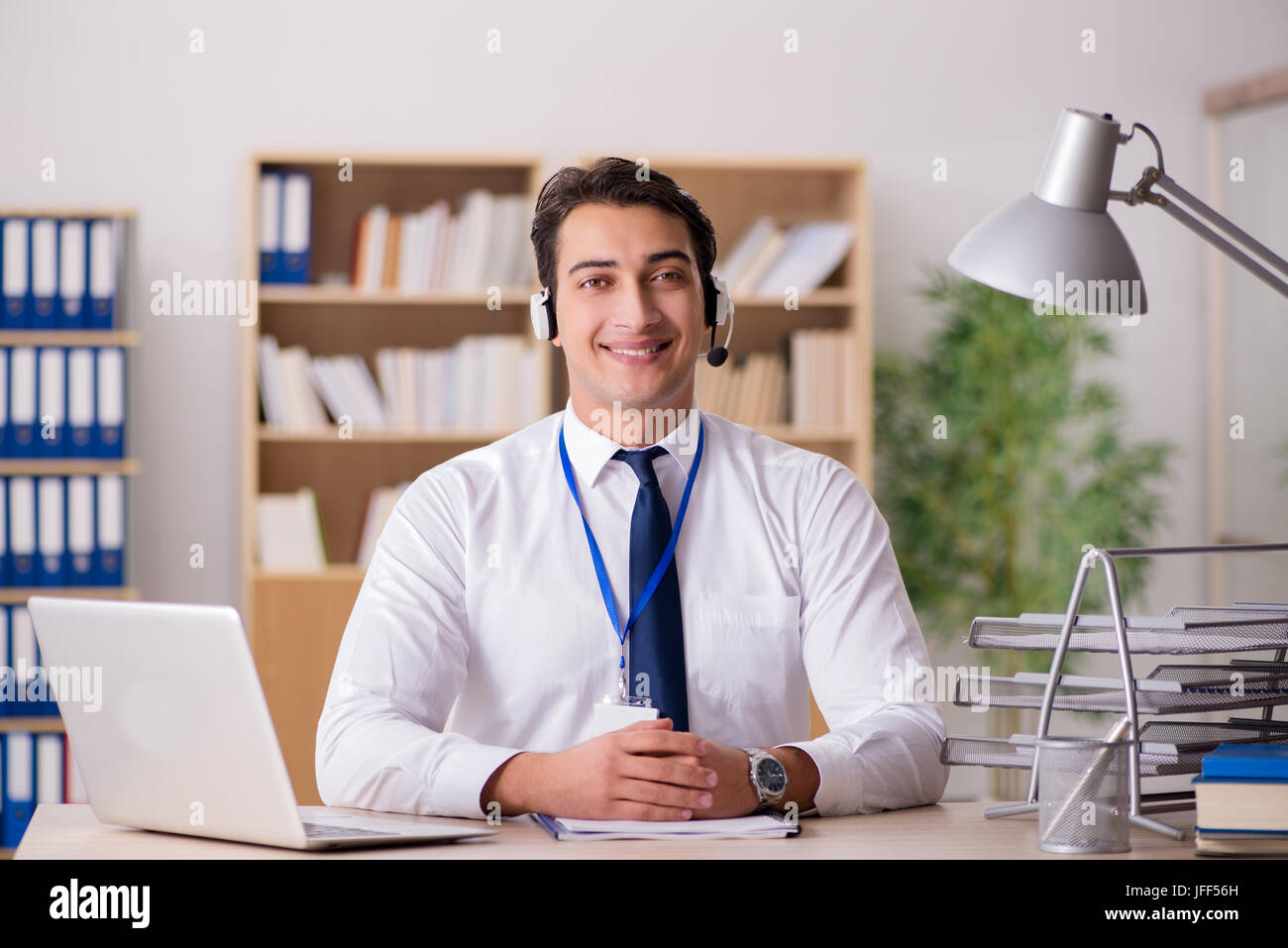 Handsome customer service clerk with headset Stock Photo - Alamy