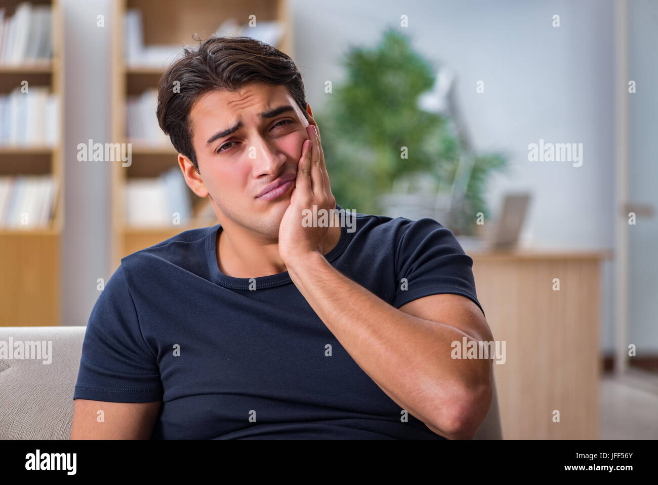 Young handsome man suffering from pain Stock Photo - Alamy