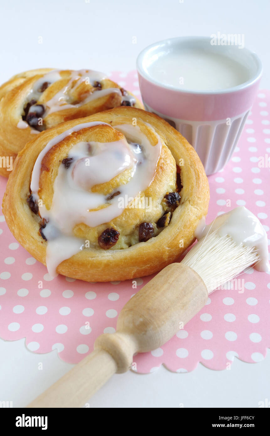 raisin sticky bun with sugar icing Stock Photo - Alamy