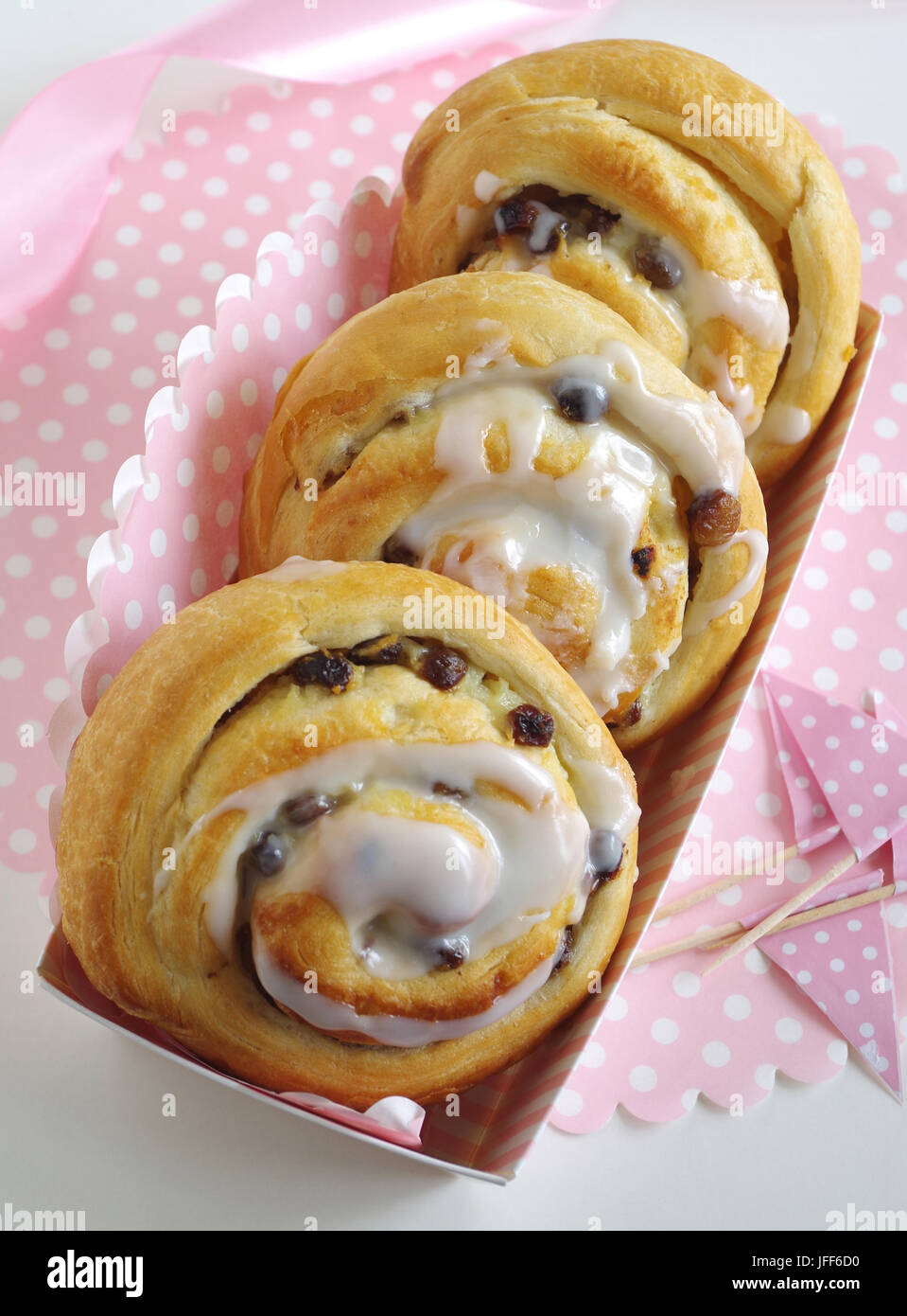 raisin sticky bun with sugar icing Stock Photo - Alamy
