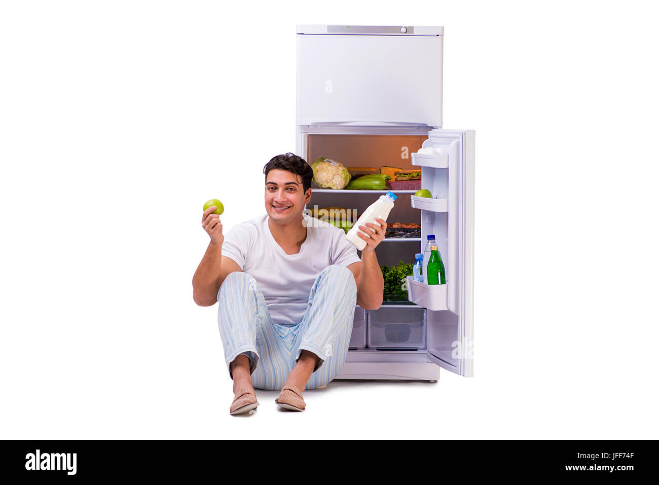 Man next to fridge full of food Stock Photo - Alamy