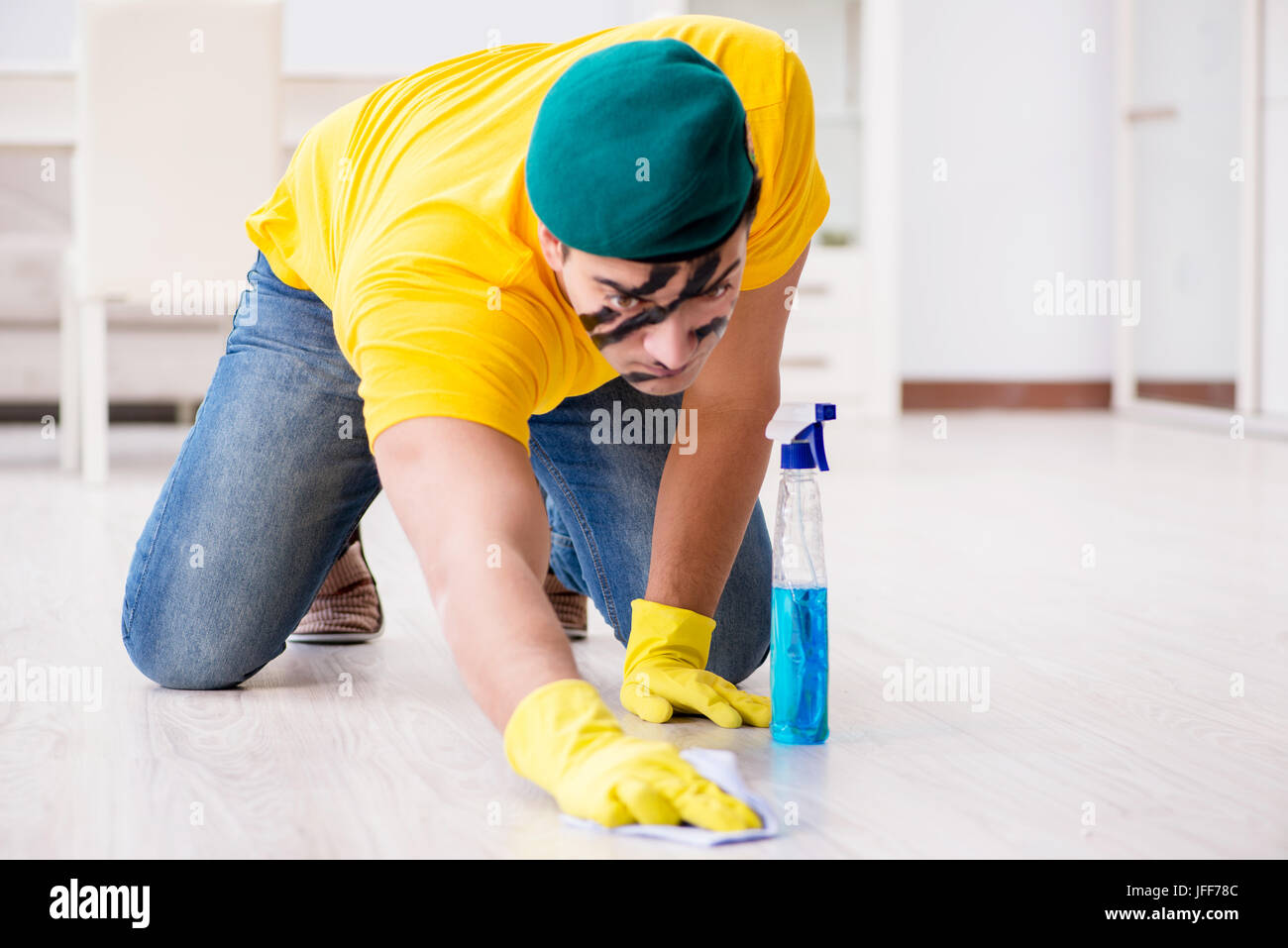 Man in military style cleaning the house Stock Photo - Alamy