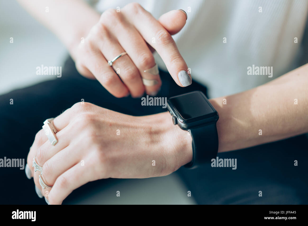Woman's hand touching the screen of a smart watch Stock Photo - Alamy