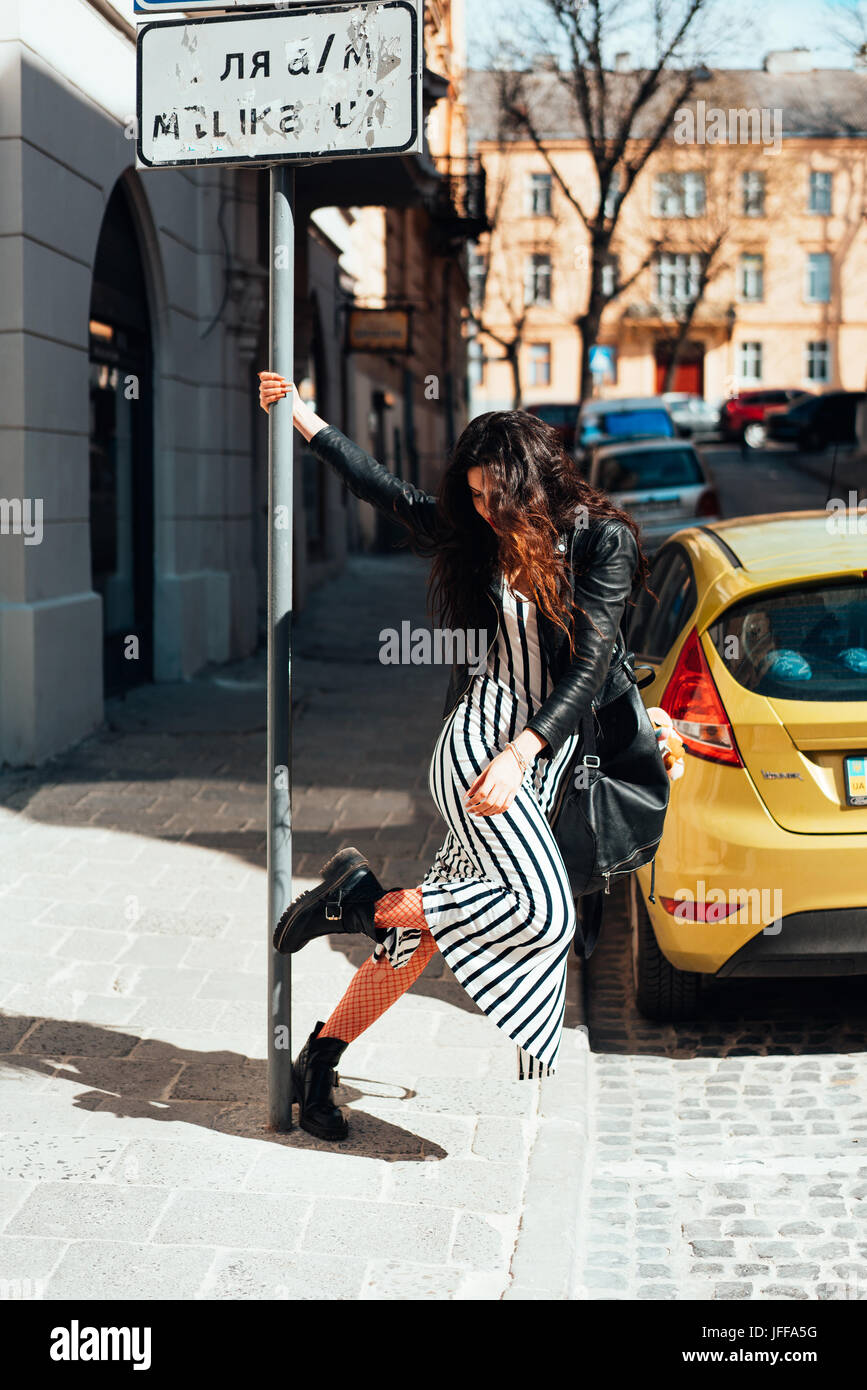 Beautiful fashionable lady posing on old street Stock Photo - Alamy