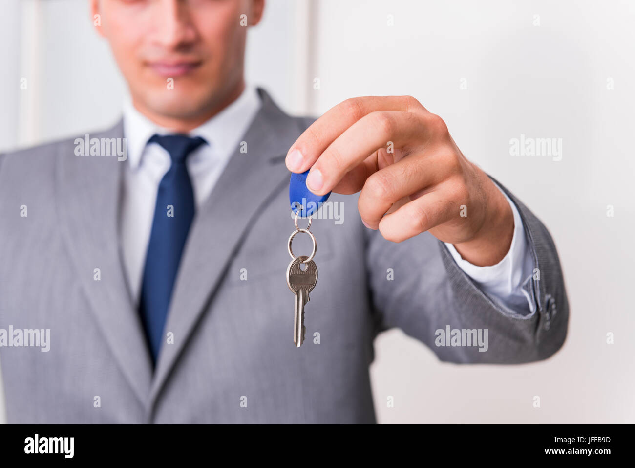 Real estate agent with key from new house Stock Photo - Alamy
