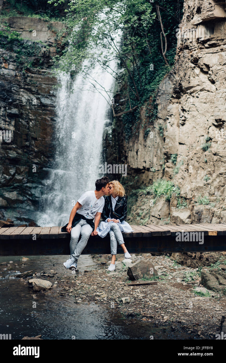 Boy girl sitting on bridge hi-res stock photography and images - Alamy