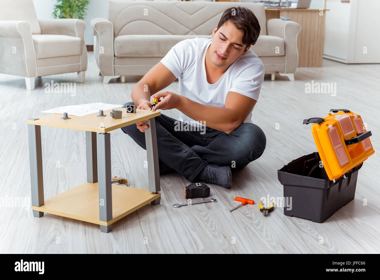 Man assembling furniture at home Stock Photo - Alamy