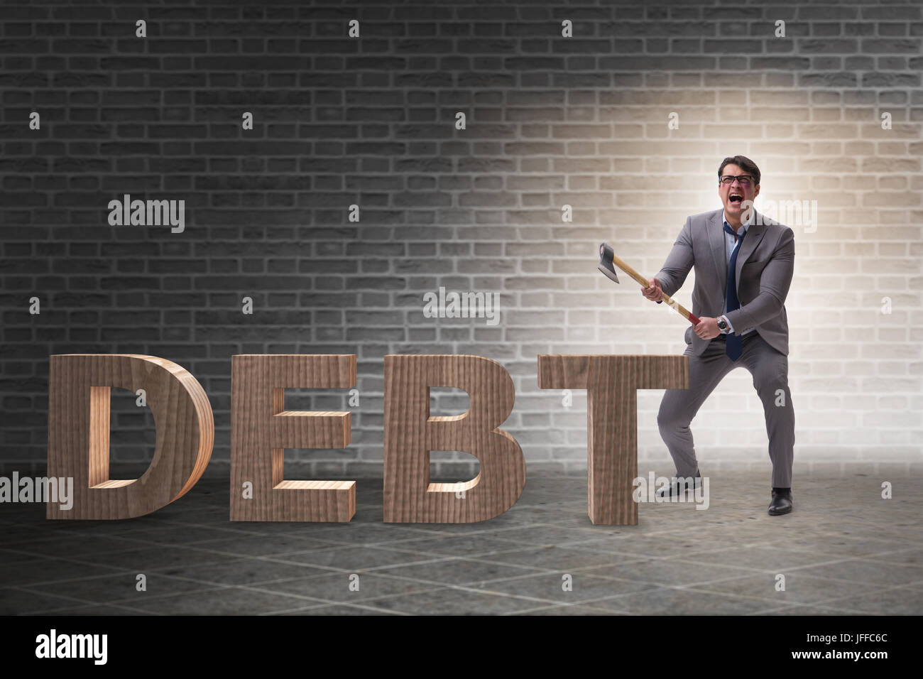 Angry man with axe axing the word debt Stock Photo - Alamy