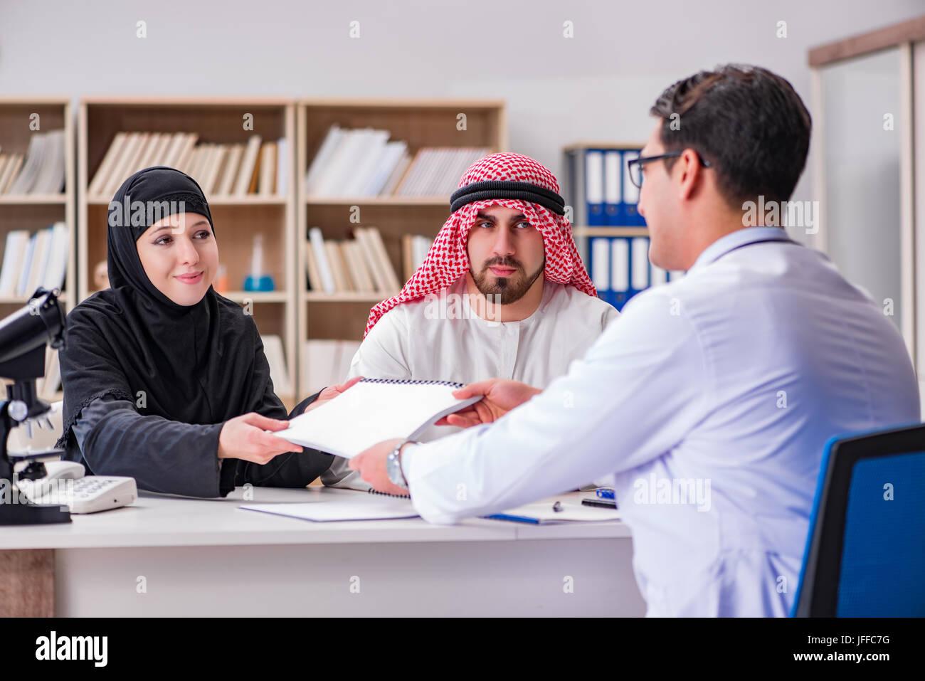 Doctor consulting arab family at hospital Stock Photo - Alamy