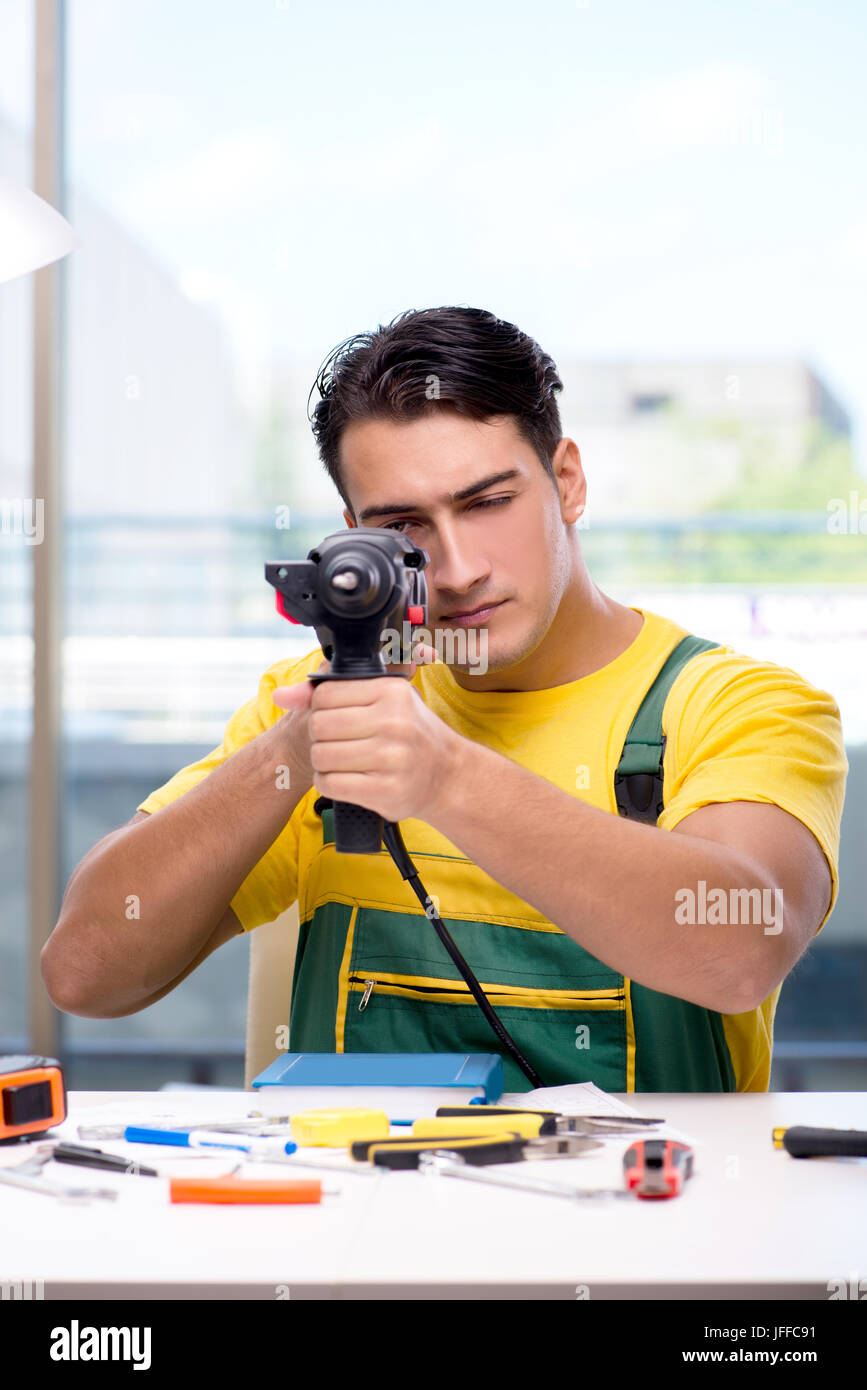 Construction worker sitting at the desk Stock Photo - Alamy