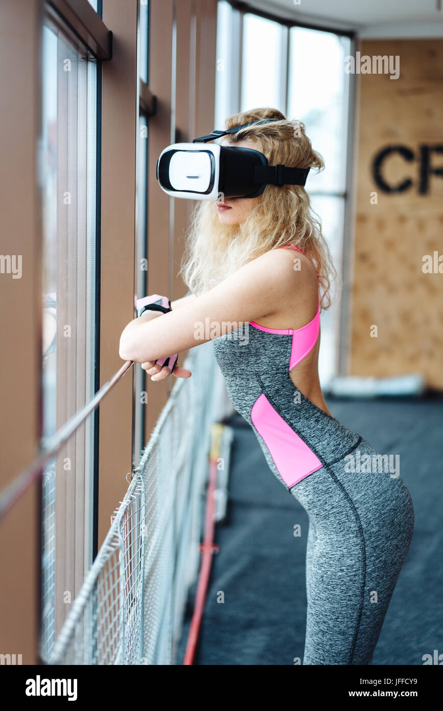 Beautiful girl in the gym with VR headset Stock Photo - Alamy