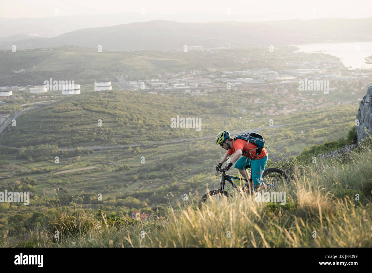 Mountain biker riding bike downhill Stock Photo - Alamy