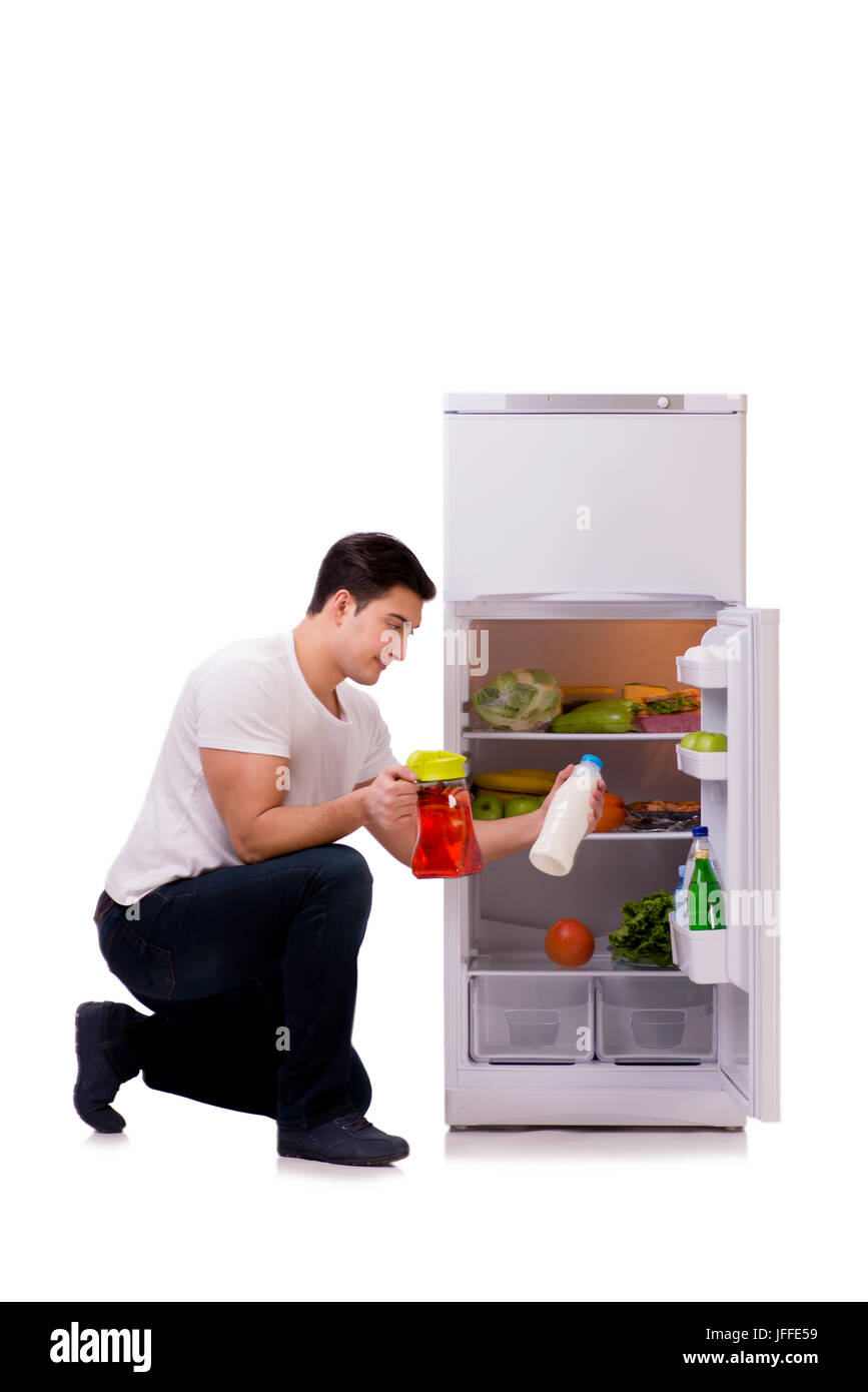 Man next to fridge full of food Stock Photo - Alamy