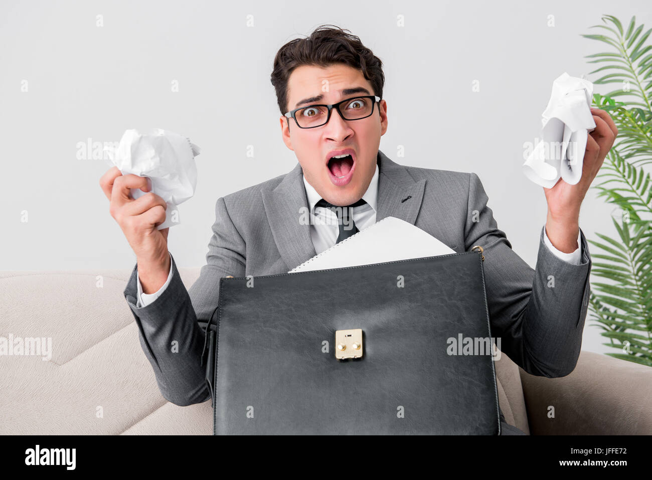 Angry businessman with crumbled paper Stock Photo - Alamy