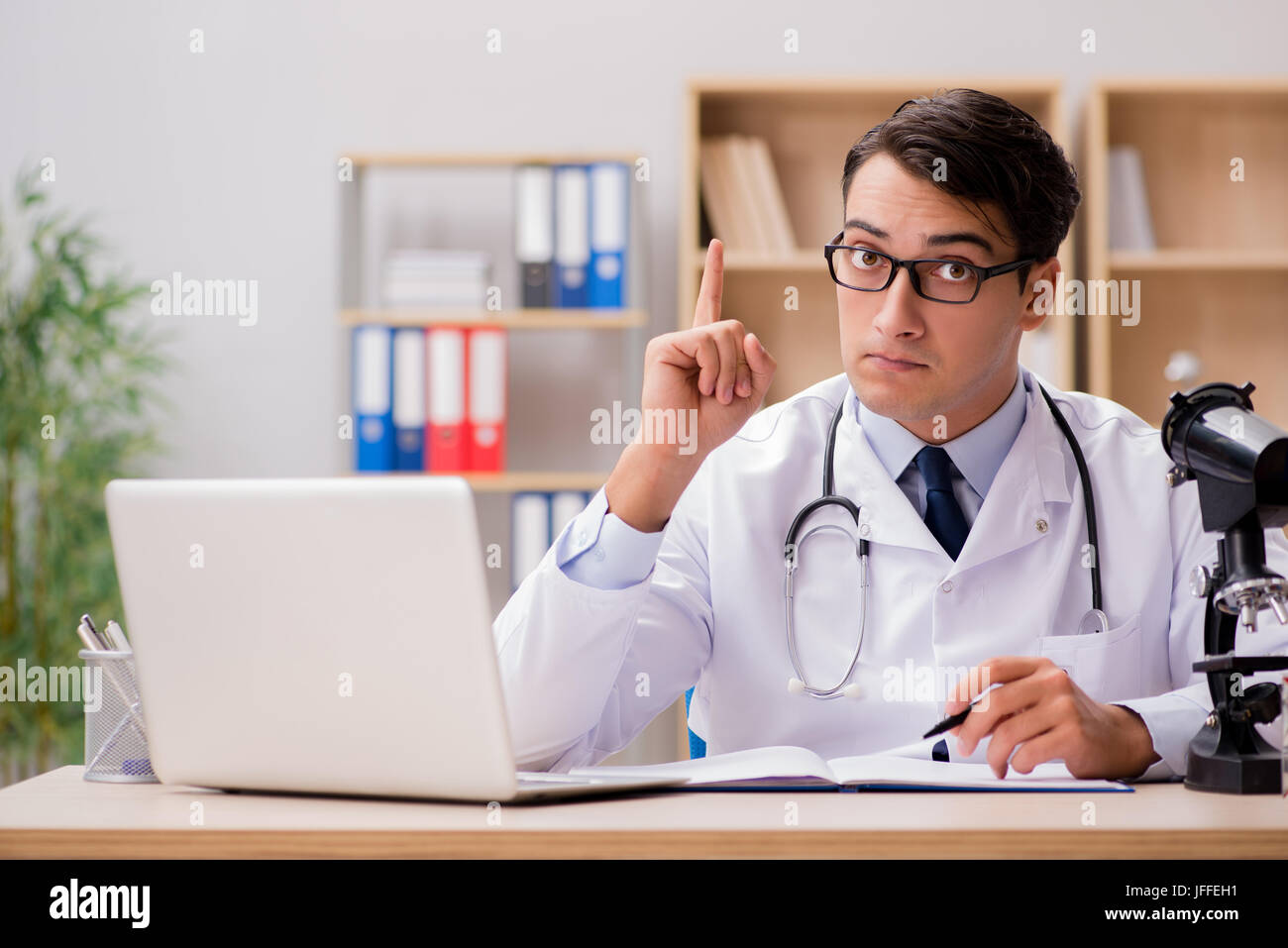 Doctor working computer in bright hi-res stock photography and images ...