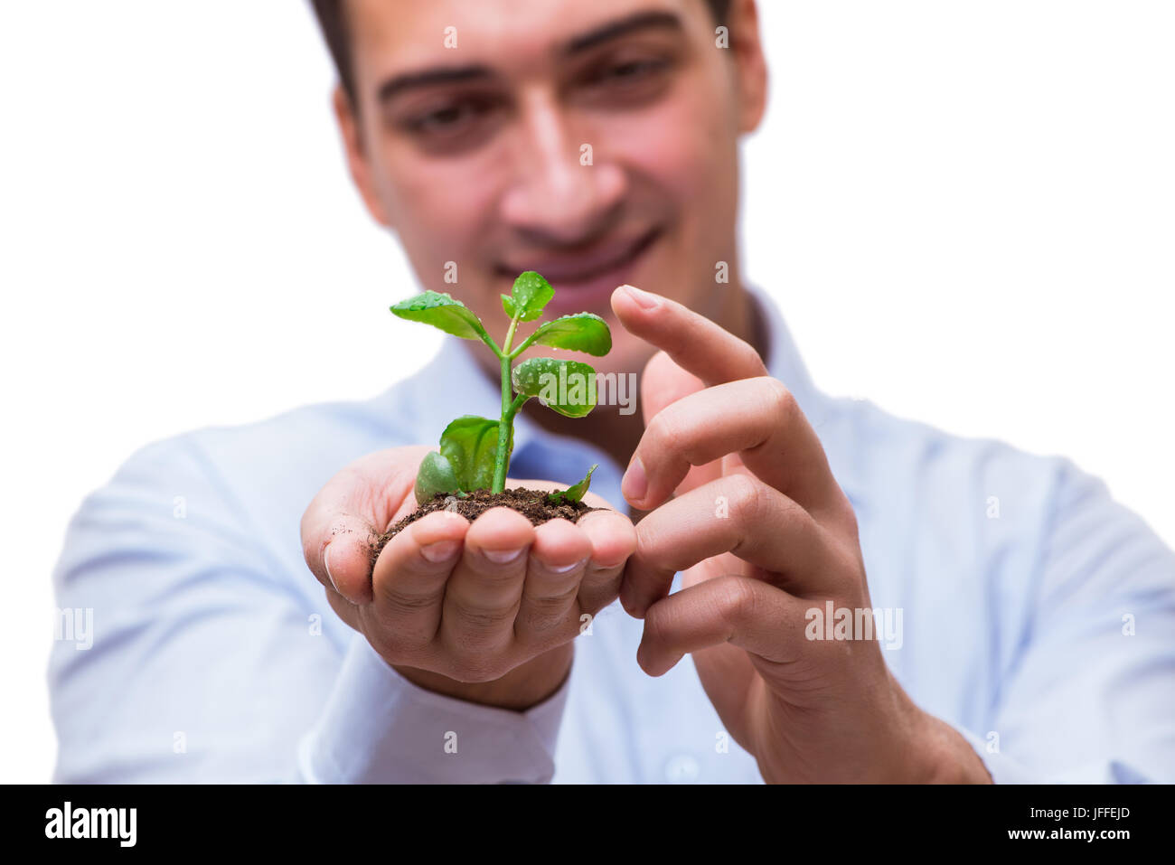 Man holding green seedling isolated on white Stock Photo - Alamy