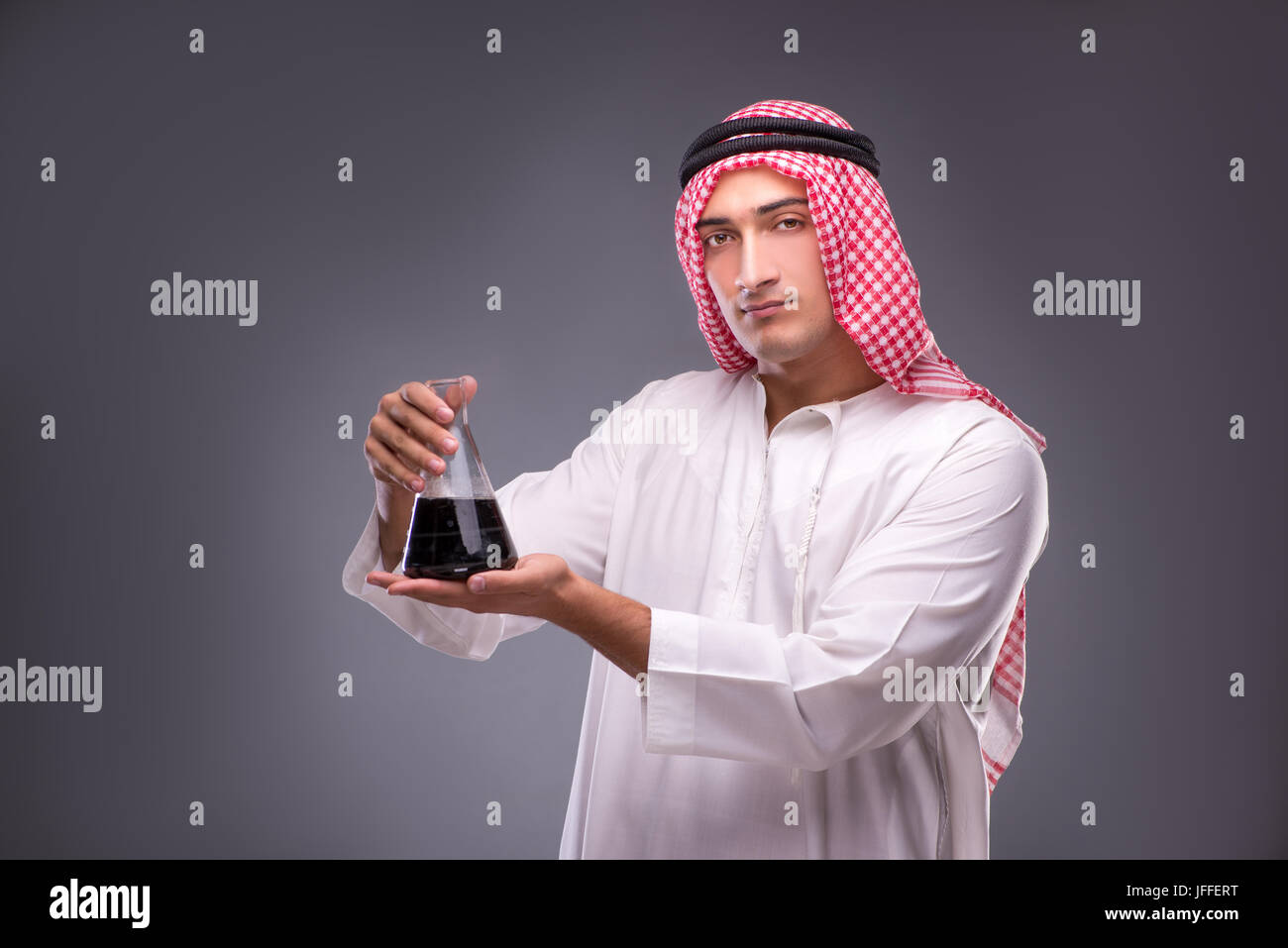 Arab with oil on gray background Stock Photo - Alamy