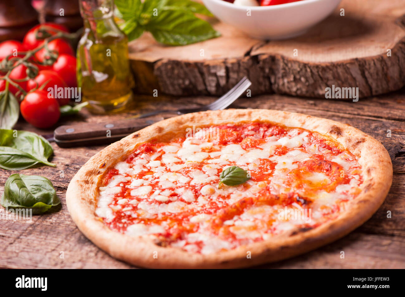 Italian Pizza on rustic wooden table Stock Photo - Alamy