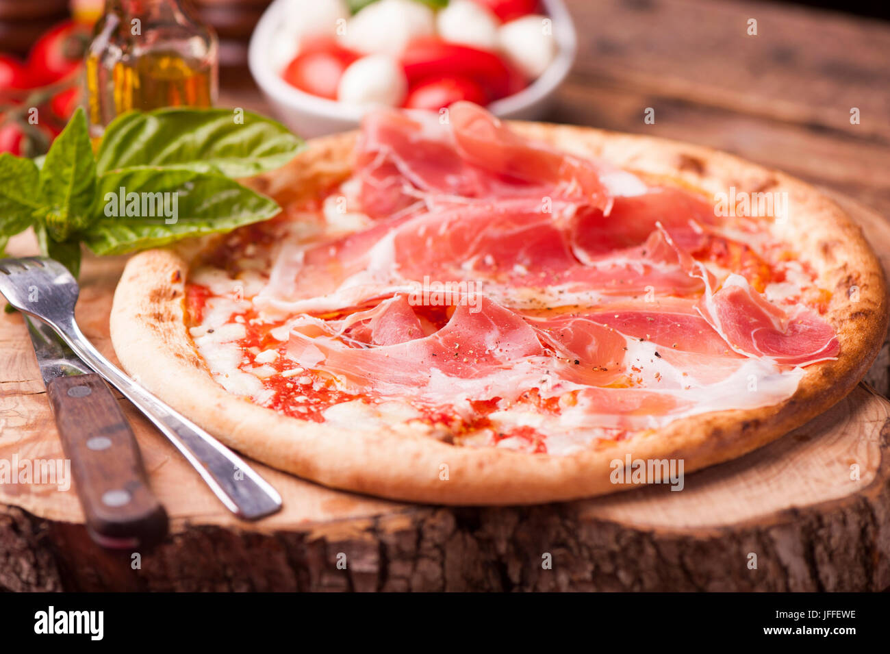 Italian Pizza on rustic wooden table Stock Photo - Alamy