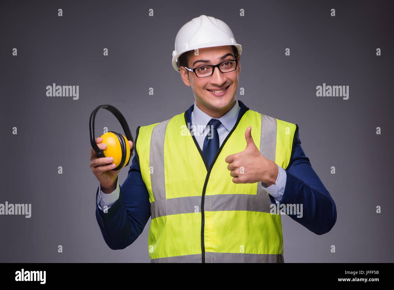 Man wearing hard hat and construction vest Stock Photo - Alamy