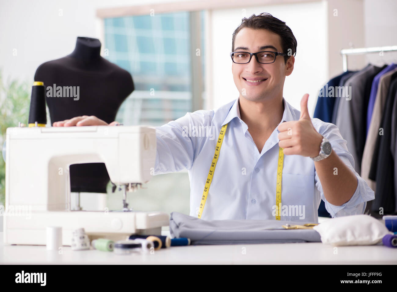 Young man tailor working on new clothing Stock Photo - Alamy