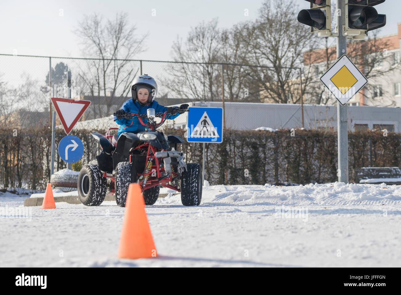 Boy riding quad bike on snow Stock Photo - Alamy