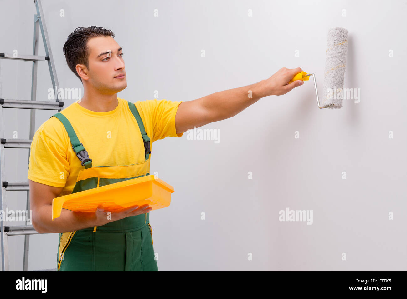 Man painting the wall in DIY concept Stock Photo - Alamy