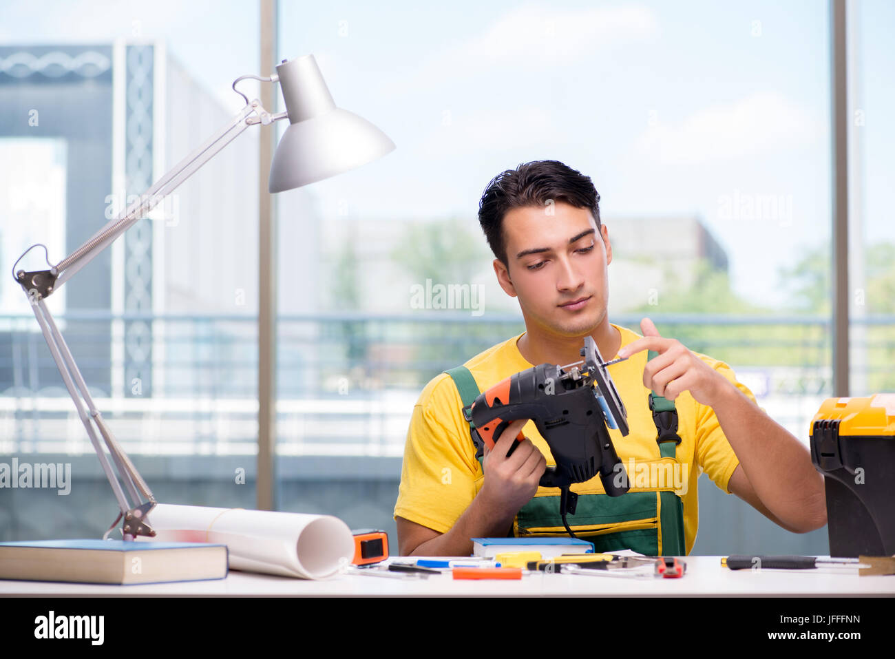 Construction worker sitting at the desk Stock Photo - Alamy