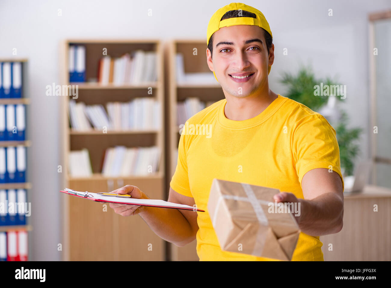 Delivery man delivering parcel box Stock Photo - Alamy