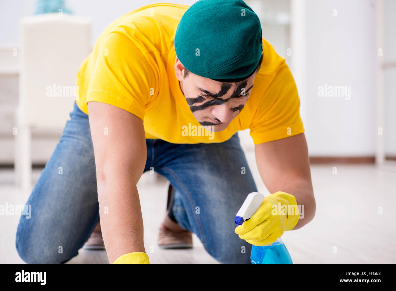 Man in military style cleaning the house Stock Photo - Alamy