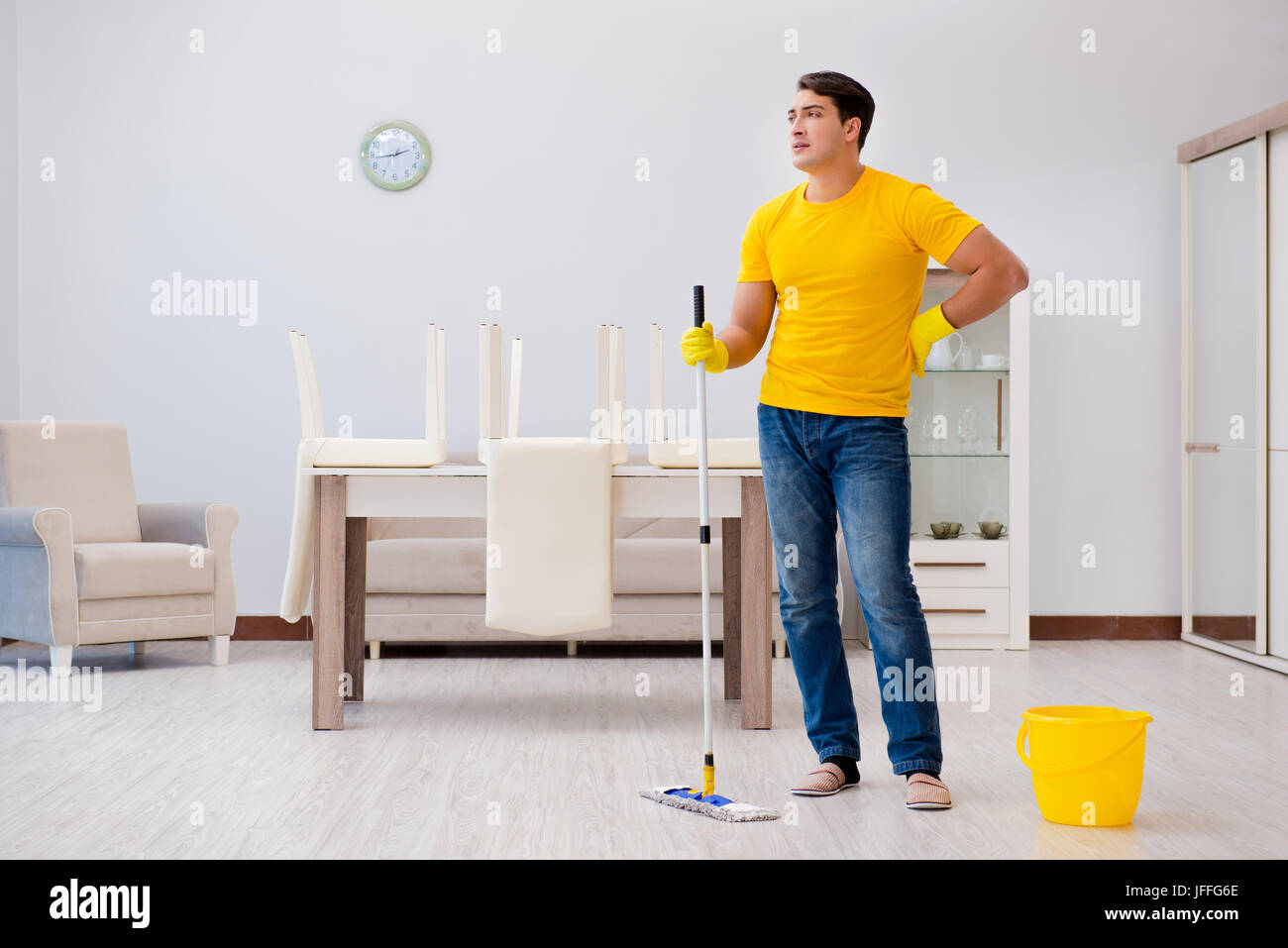 Man cleaning the house helping his wife Stock Photo - Alamy