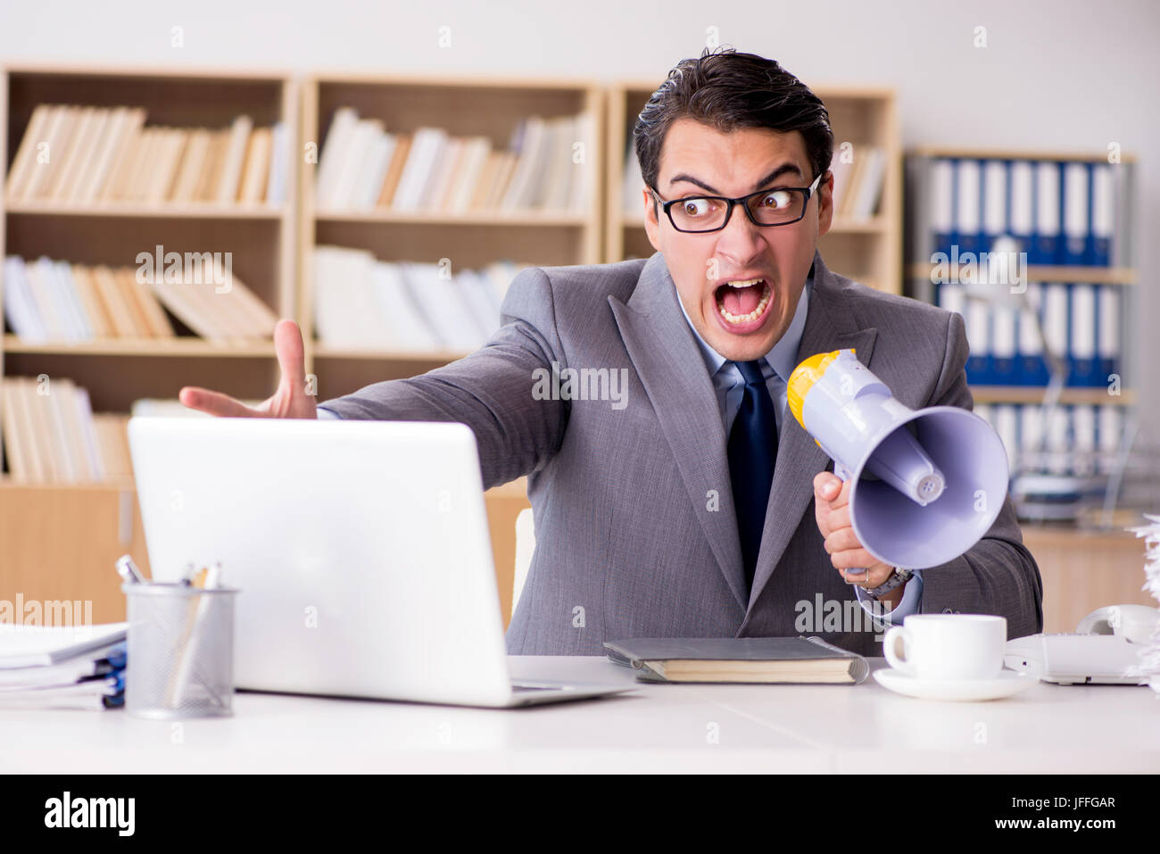 Angry businessman working in the office Stock Photo - Alamy