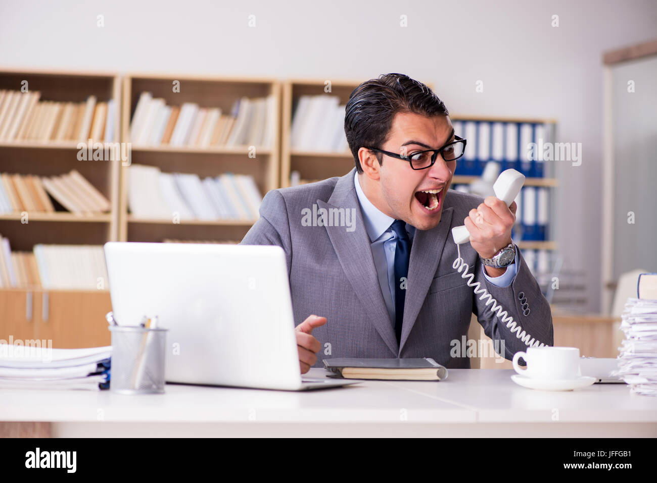 Angry businessman working in the office Stock Photo - Alamy