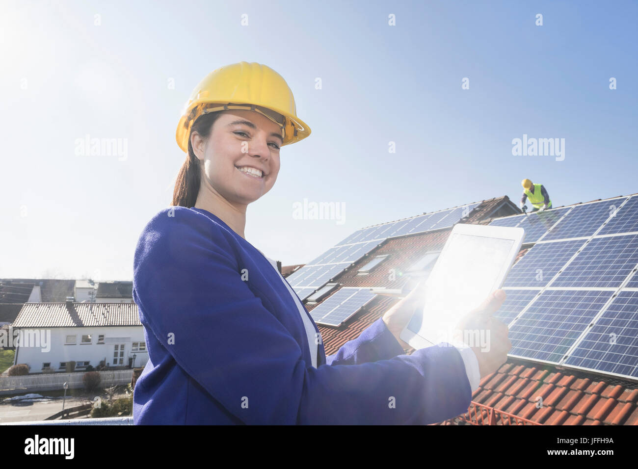 Female engineer controlling installation of solar panels Stock Photo ...